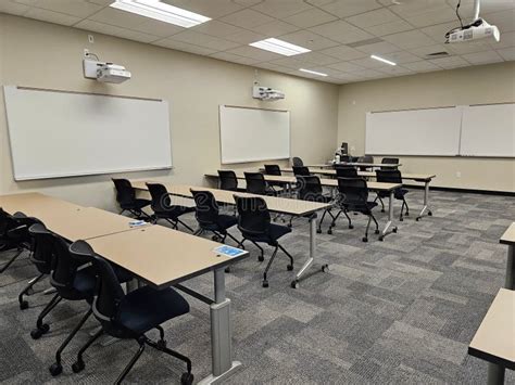 Empty Classroom Interior With Rows Of Desks And A Projector Suspended