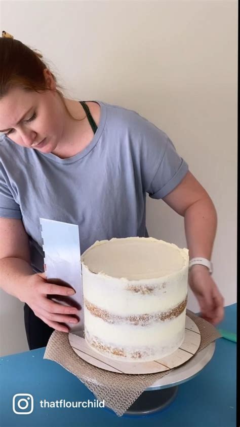 Naked Cake Stacking And Filling Raspberry Vanilla Cake Wedding Cake