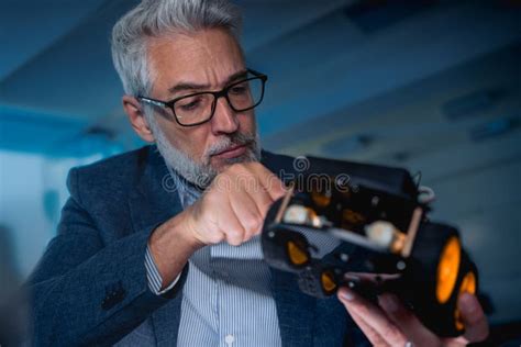 Automation Robotics Engineer Assembling Robotic Car Prototype For Delivery Warehouse Concept