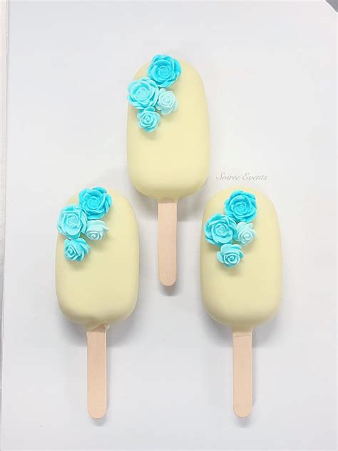 White Chocolate Coated Cake Popsicles With Blue Sugar Flowers Soiree