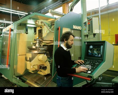 Model Released Metal Machining Robot Technician Programming A Metal Machining Robot Stock