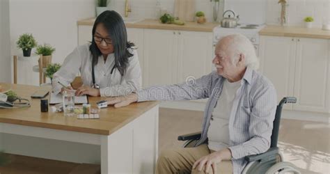 Nurse Checking Oxygen Saturation With Sensor Examining Patient At Home