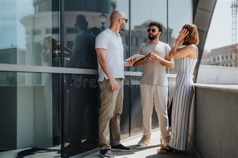 Successful Business Team Discussing Project Development In Urban City