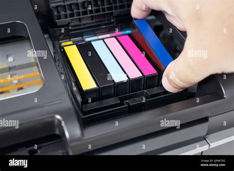 Human Hand Changing A Blue Ink Cartridge Of A Multicolor Inkjet Printer Stock Photo Alamy