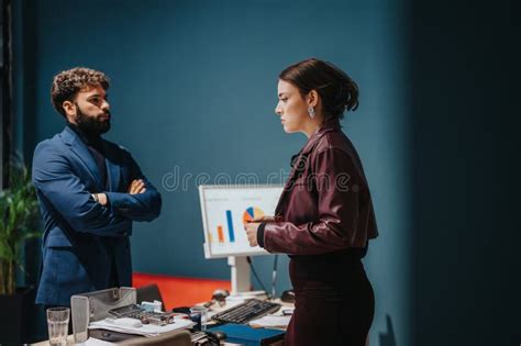 Business Professionals Discussing Analytics With A Computer Display In Modern Office Stock Image