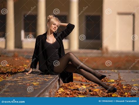Beautiful Blonde Woman With Perfect Legs In Pantyhose Posing Outdoor At