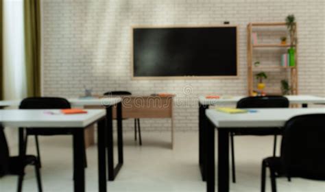 Empty Modern School Classroom With Desks Chairs And Chalkboard At Daylight Workspace For