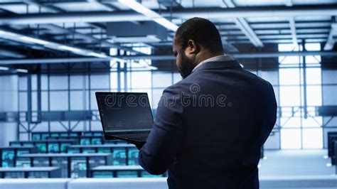 Computer Scientist In Server Farm Using Laptop To Patch Network Issues Stock Image Image Of