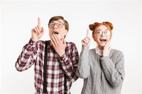 Premium Photo Happy Couple Of Babe Nerds Pointing Fingers Up