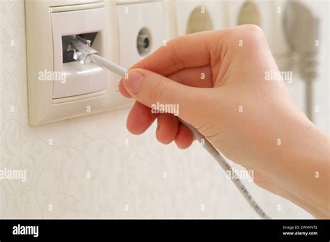 A Woman S Hand Connects The Internet Cable To A Socket Rj 45 Stock Photo Alamy