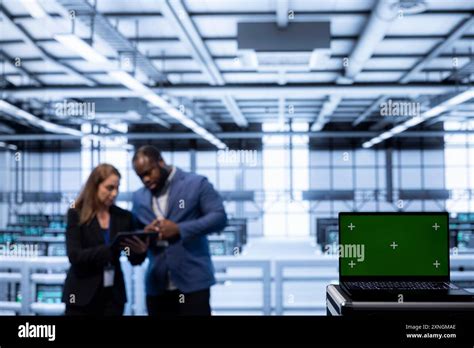 Software Developers Using Green Screen Laptop In Data Center Making