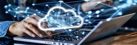 Close Up Of Hands Typing On Laptop With Glowing Cloud Computing Icon