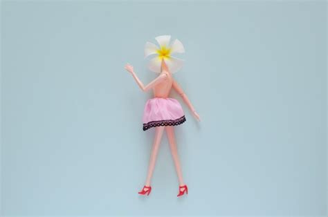 Premium Photo Female Doll Naked On Top Posing With Frangipani Flower Minimal Beauty And
