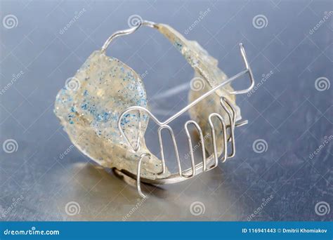 Gray Dental Braces Or Retainer For Teeth On Metall Background Stock