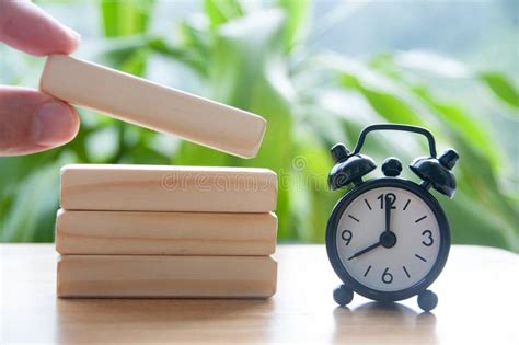 Table Alarm Clock Pointing At 8 Am With Wooden Blocks With Customizable Space For Text Stock