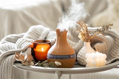 Premium Photo Aroma Composition With A Modern Aroma Oil Diffuser And A Knitted Element