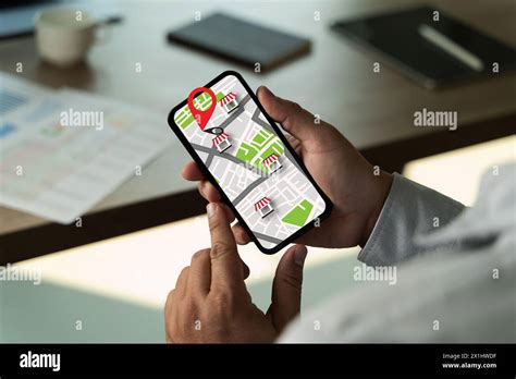 Hand Holding Cphone With Navigation LOCAL Map Online Shopping And Local Shop Support Stock Photo