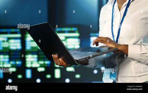 Employee Strolling Through Data Center Hardware Clusters Providing Processing Resources For