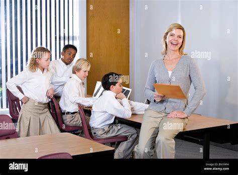 Diverse Elementary School Students In Classroom With Teacher Stock