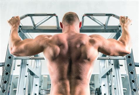 Babe Sexy Bodybuilder Man Is Doing His Fitnes Workout In The Gym Pushup Biceps Curls Pull