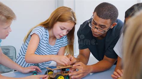 Students With Male Teacher In School Computer Class Building And