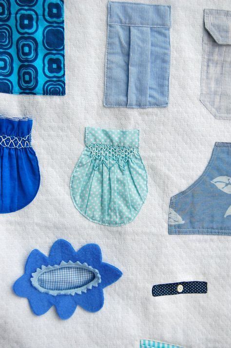 Several Different Types Of Clothing And Accessories On A White Cloth Background Including Blue Ones