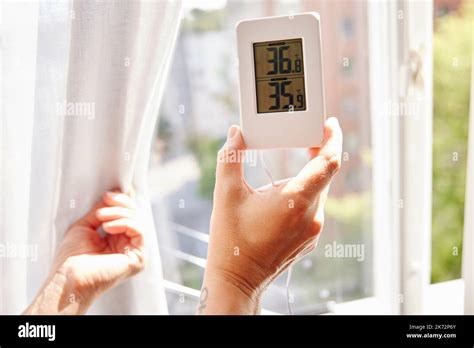 Woman Holding Thermostat At Home Stock Photo Alamy