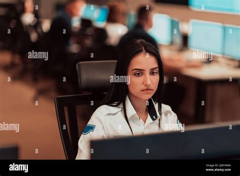 Female Security Operator Working In A Data System Control Room Offices Technical Operator