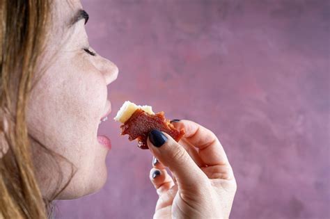 Premium Photo Woman Going To Bite Slices Of Guava Sweet And Cheese