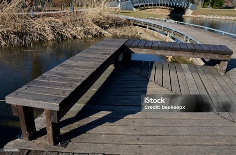 나무 판자 부두 호수 물 위의 바닥으로 구동 기둥에 좁은 곡선 경로로 만든 떠있는 산책로 난간이 없습니다 휠체어용 난간이 낮은 더 많은 디자인 보도 노랑에 대한 스톡 사진