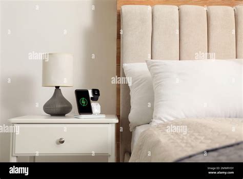 Different Gadgets Charging On Wireless Pad In Bedroom Stock Photo Alamy