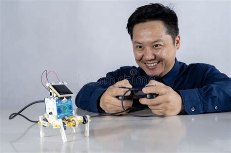 Asian Man Is Building A Robot Project In His Home Robots Control Science Lessons And Coding