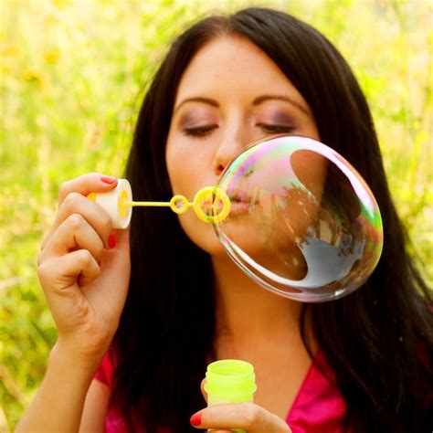 Premium Photo Woman Starts Soap Bubbles