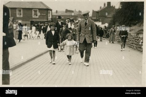 Working Class Gent Walks Proudly Along A British Seaside Seafront With