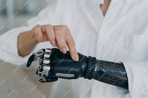 Premium Photo Woman With Disability Turns On High Tech Prosthetic Arm Showing Bionic