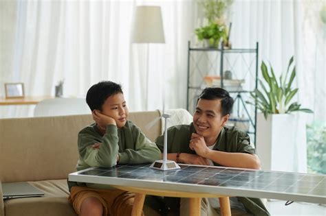 Premium Photo Father And Son Looking At Wind Turbine Model