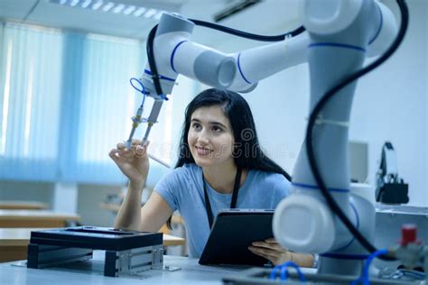 Female Robotics Engineer Working With Programming And Manipulating