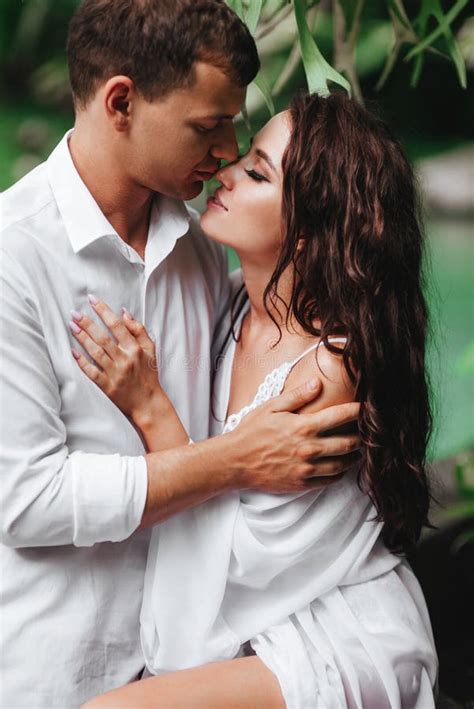 Happy Couple Kissing While Relaxing In Outdoor Spa Swimming Pool Stock