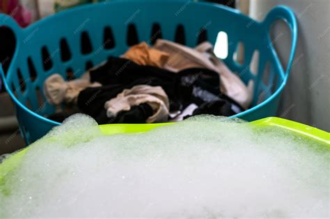 Premium Photo Washing Clothes By Hand With Detergent Bubble Foam