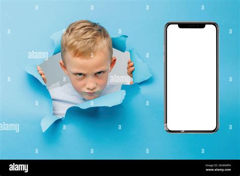 Angry Cute Boy Is Having Fun Played On Blue Background Wall Climbs