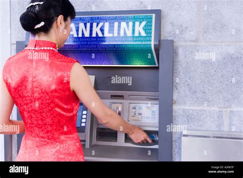 Rear View Of A Woman Using Bank ATM Machine Stock Photo Alamy