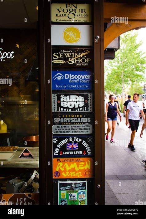 A Window Covered In Colorful Eclectic Signage Stickers And Other