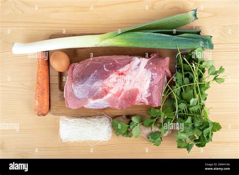 Top View Of A Set For Cooking Funchose And Pork Soup With Leeks