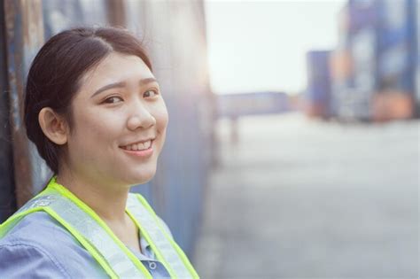 Premium Photo Asian Woman Happy Dock Worker Control Loading Containers Cargo At Shipyard