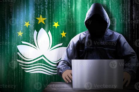 anonymous hooded hacker and flag of macau binary code cyber attack