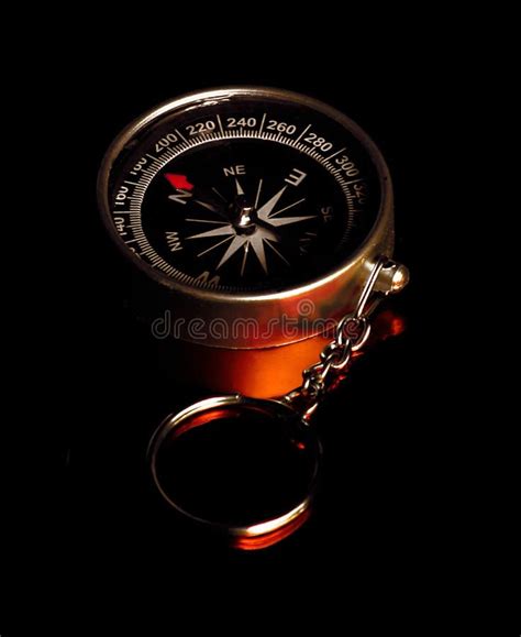 Compass Metal Compass On Black Background And Reddish Reflection