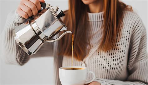 Premium Photo Woman Pouring Espresso From A Geyser Coffee Maker Into