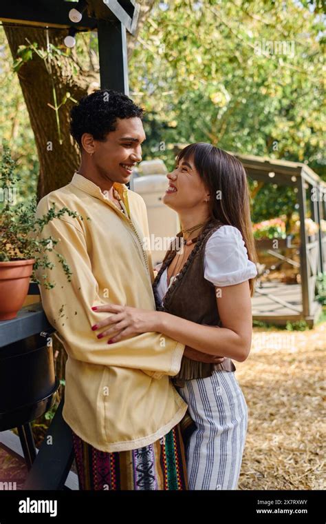 An Interracial Couple Standing Together Enjoying A Romantic Getaway In