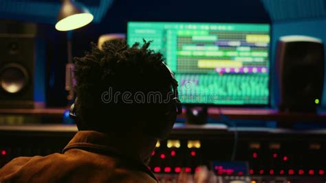 African American Tracking Engineer Processing And Mixing Sounds In
