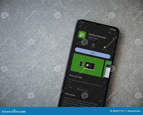 unified remote app play store page on smartphone on ceramic stone